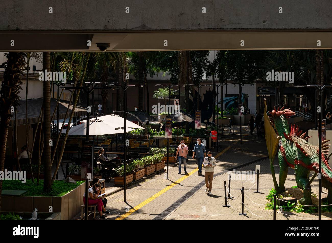 Costumers walking on the outdoor area between West Plaza shopping mall ...