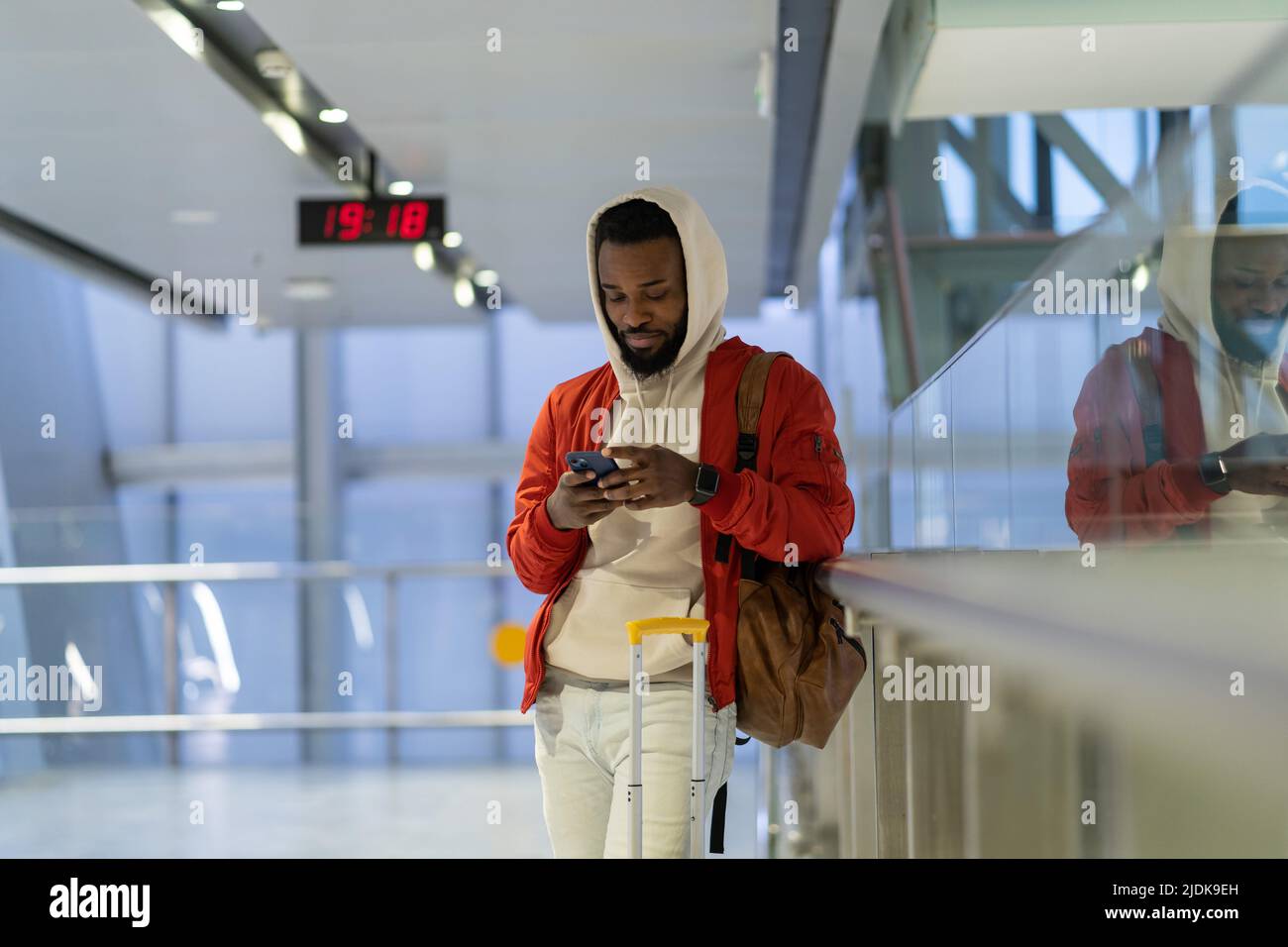 African man with smartphone in airport terminal, young black guy ...