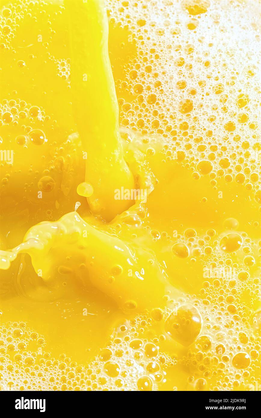 Closeup of splashing orange juice, top view. Splash of fresh sweet ...