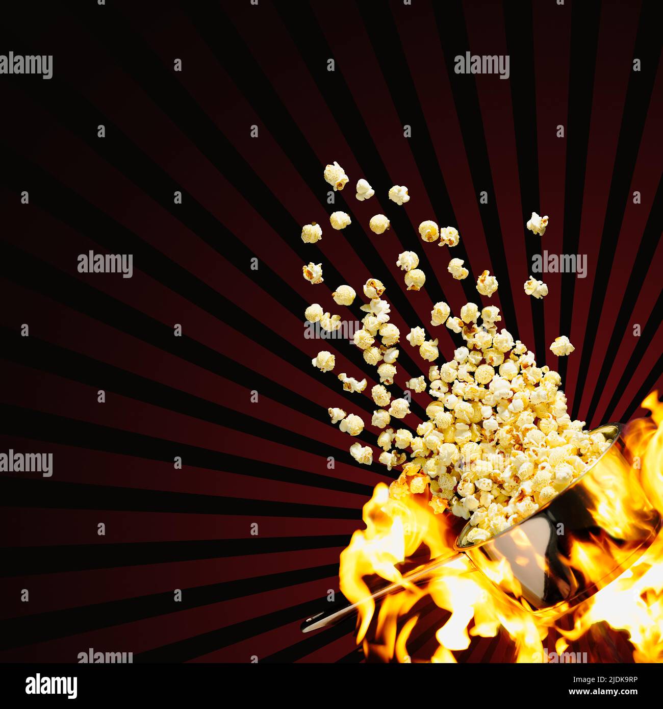 Flying popcorn on a dark background. Hot popcorn flying from pot under ...