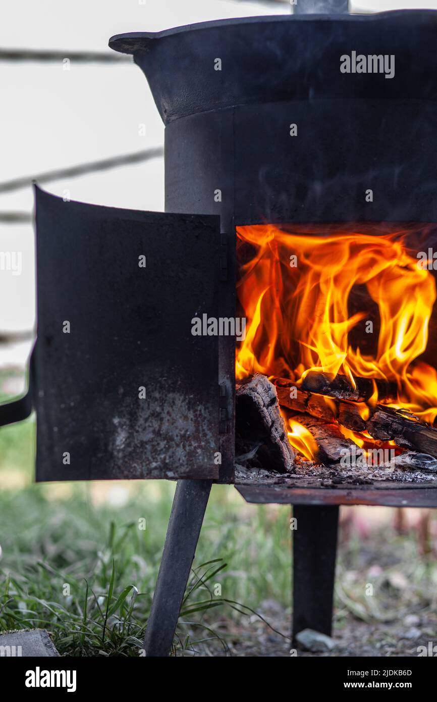 Cooking food or pilaf in a cauldron on fire. Cooking in cauldron on ...