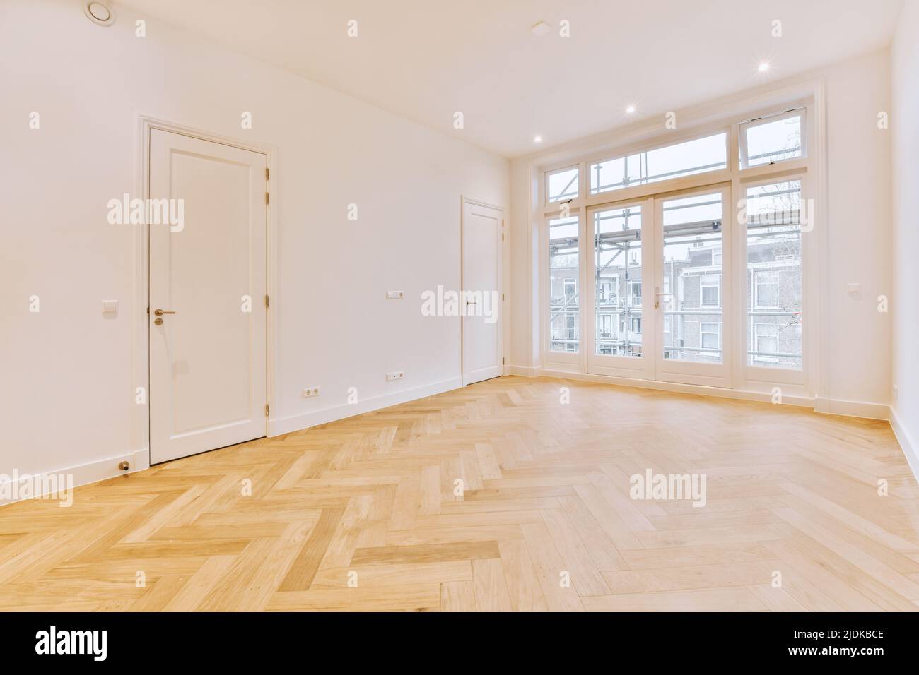 Interior of an empty white room with doors and with large balcony ...