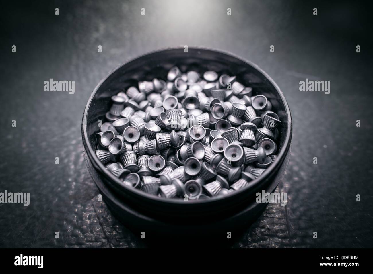 Diabolo bullets for pneumatic weapons lie in a round plastic box close ...