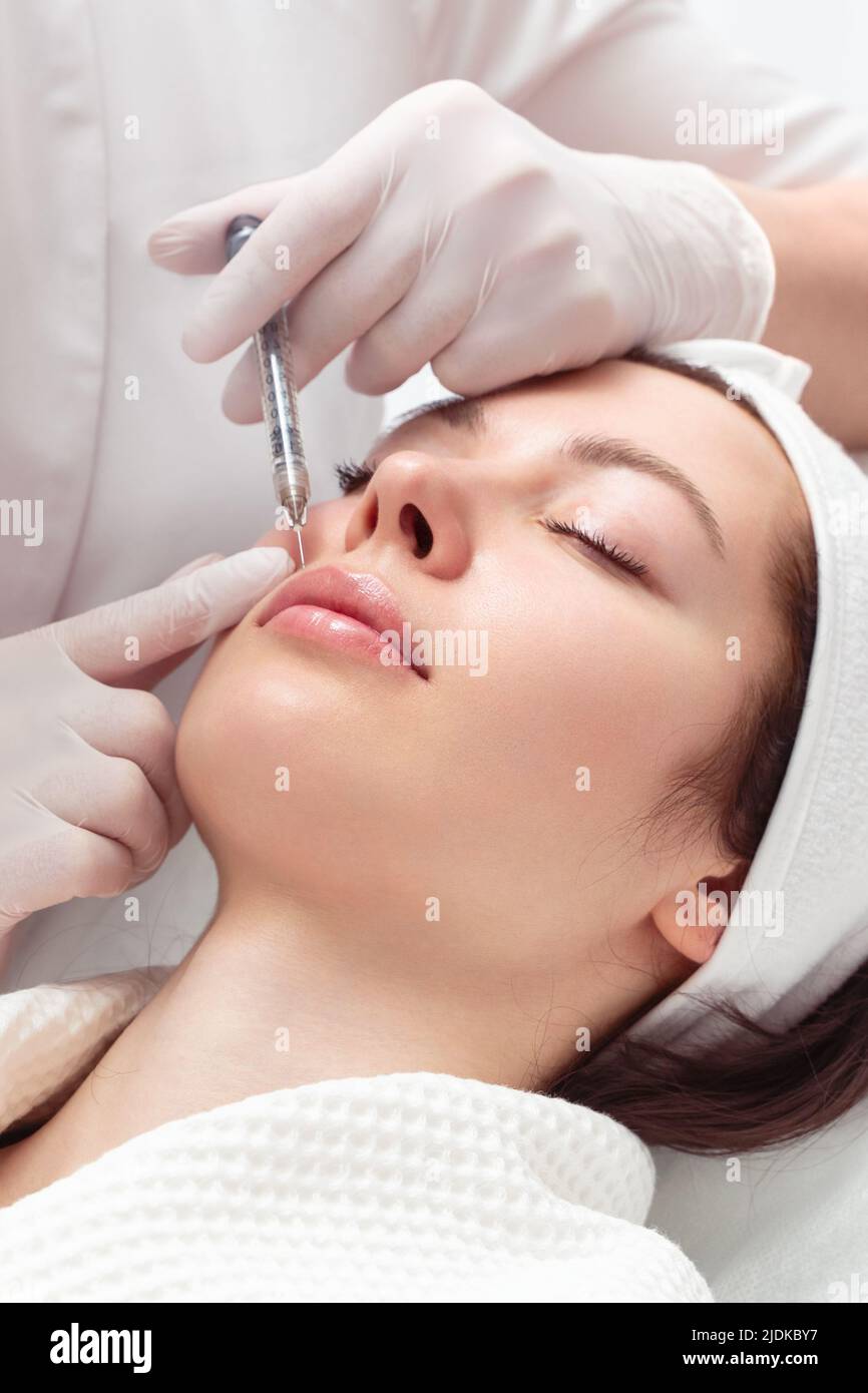 Lip augmentation and correction procedure in a cosmetology salon. The ...
