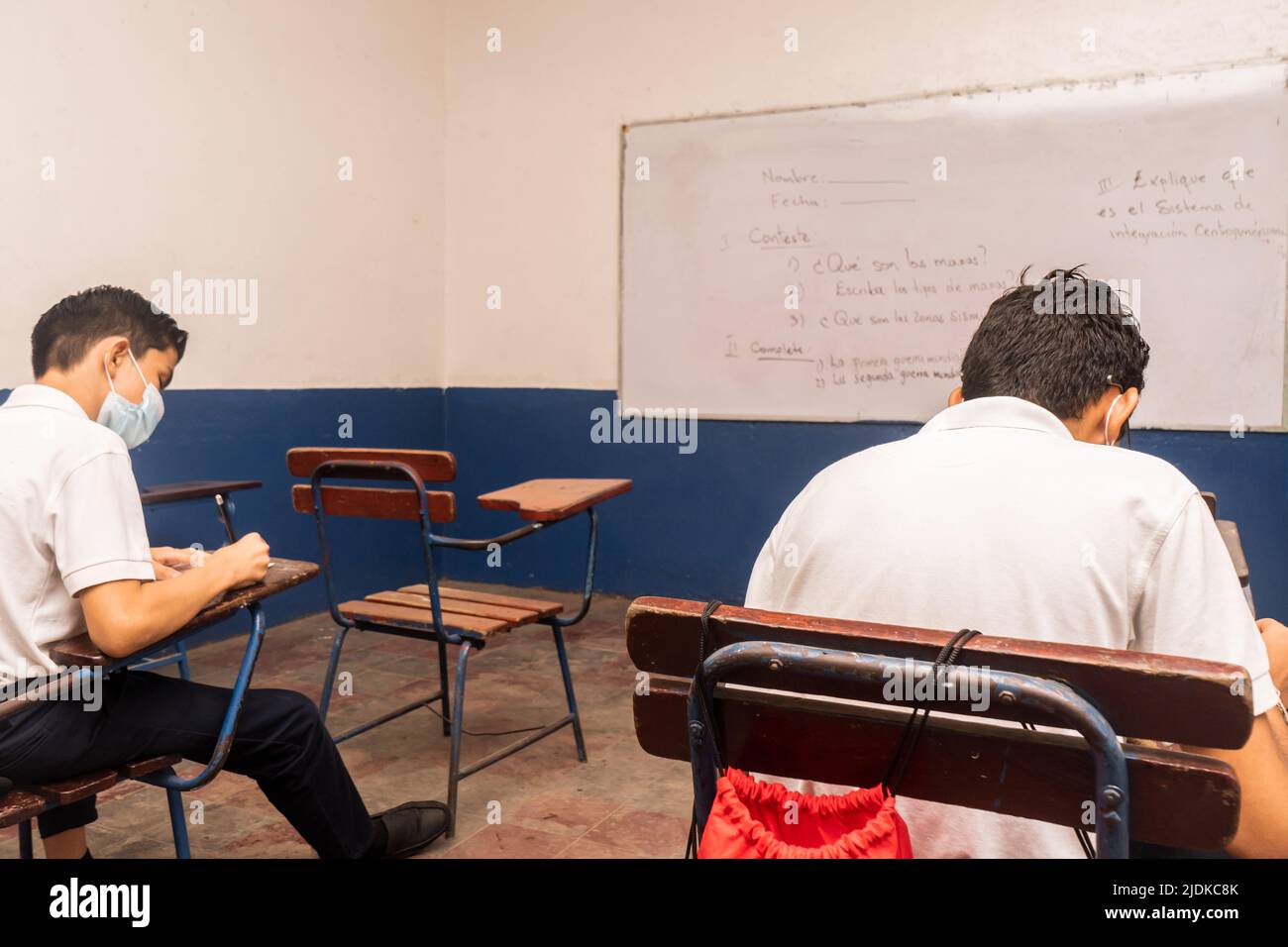 Young students taking an exam in a classroom Stock Photo - Alamy