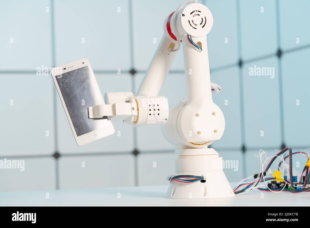 Phone in robot arm, bot concept on customer support hotline. Using ...