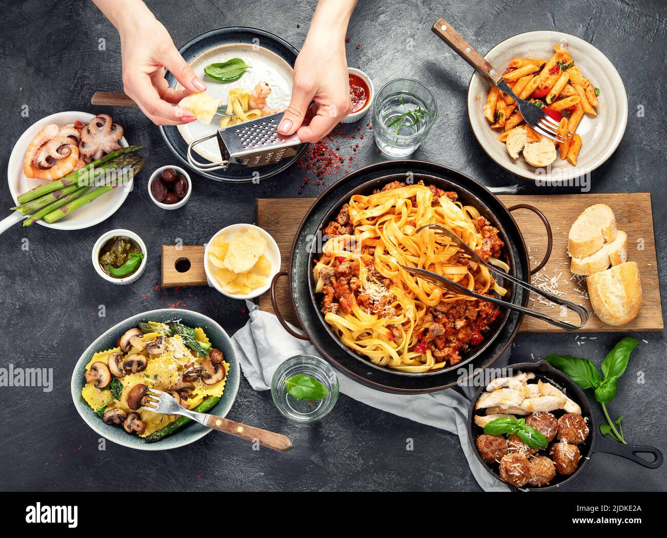 Table of italian meals on plates pasta Bolognese, ravioli, penne with ...