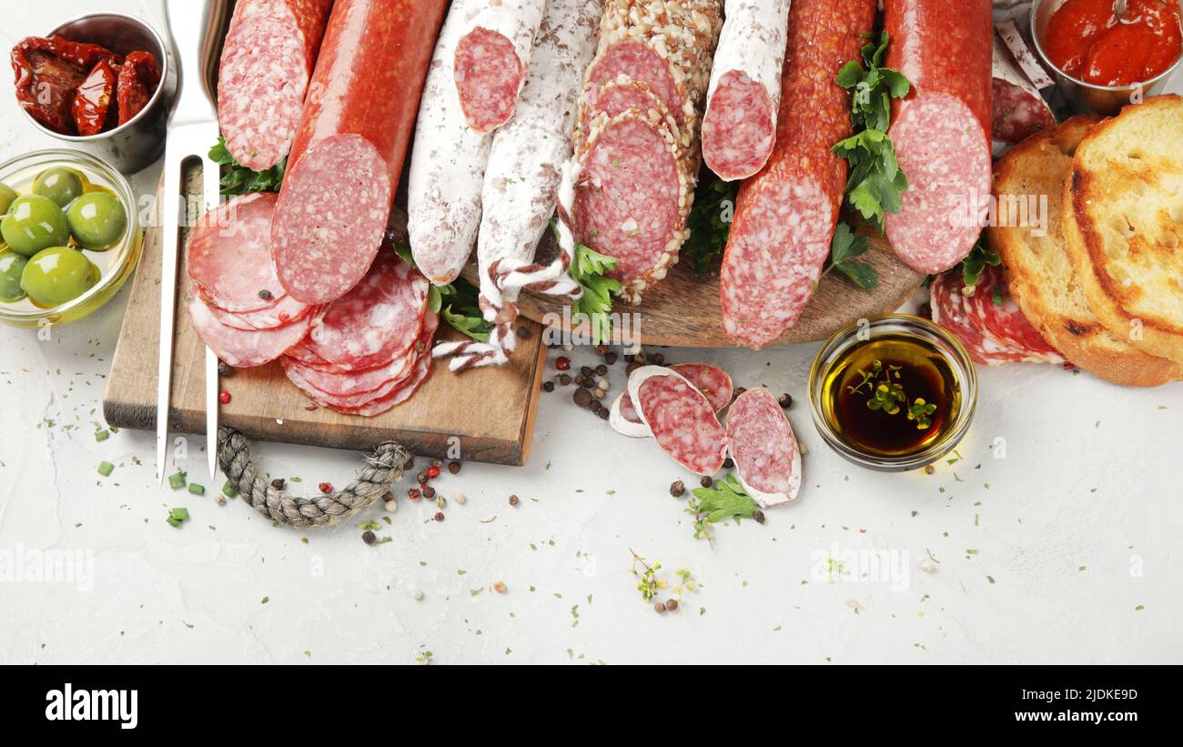 Sausages salami assortment on light background. Meat product made of ...