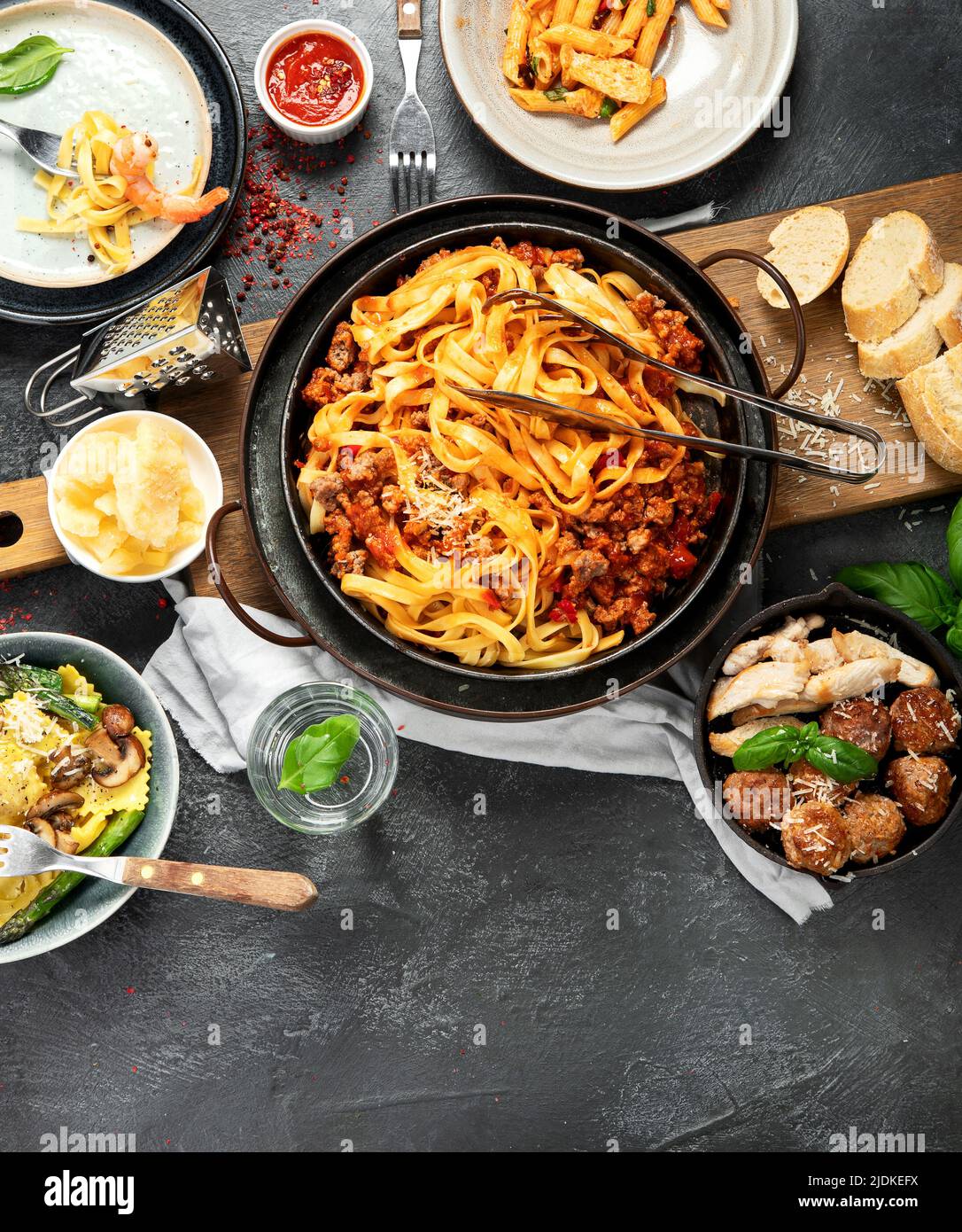 Table of italian meals on plates pasta Bolognese, ravioli, penne with ...