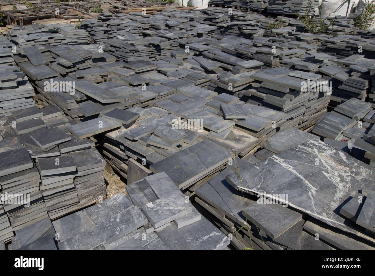 raw slate piled neatly ready for cutting into roof tiles Stock Photo ...