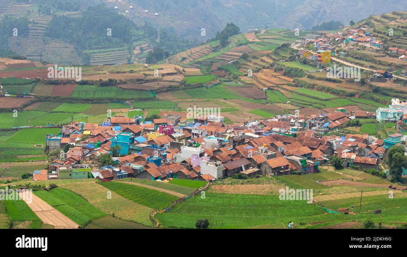 Colorful houses of Poombarai village and terraced farms located at the ...