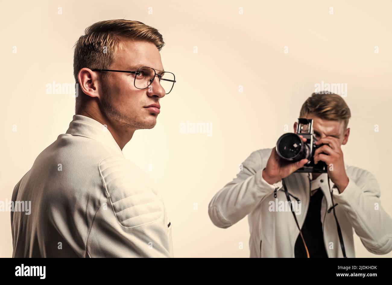twin brothers men look alike use vintage photo camera, photographing ...