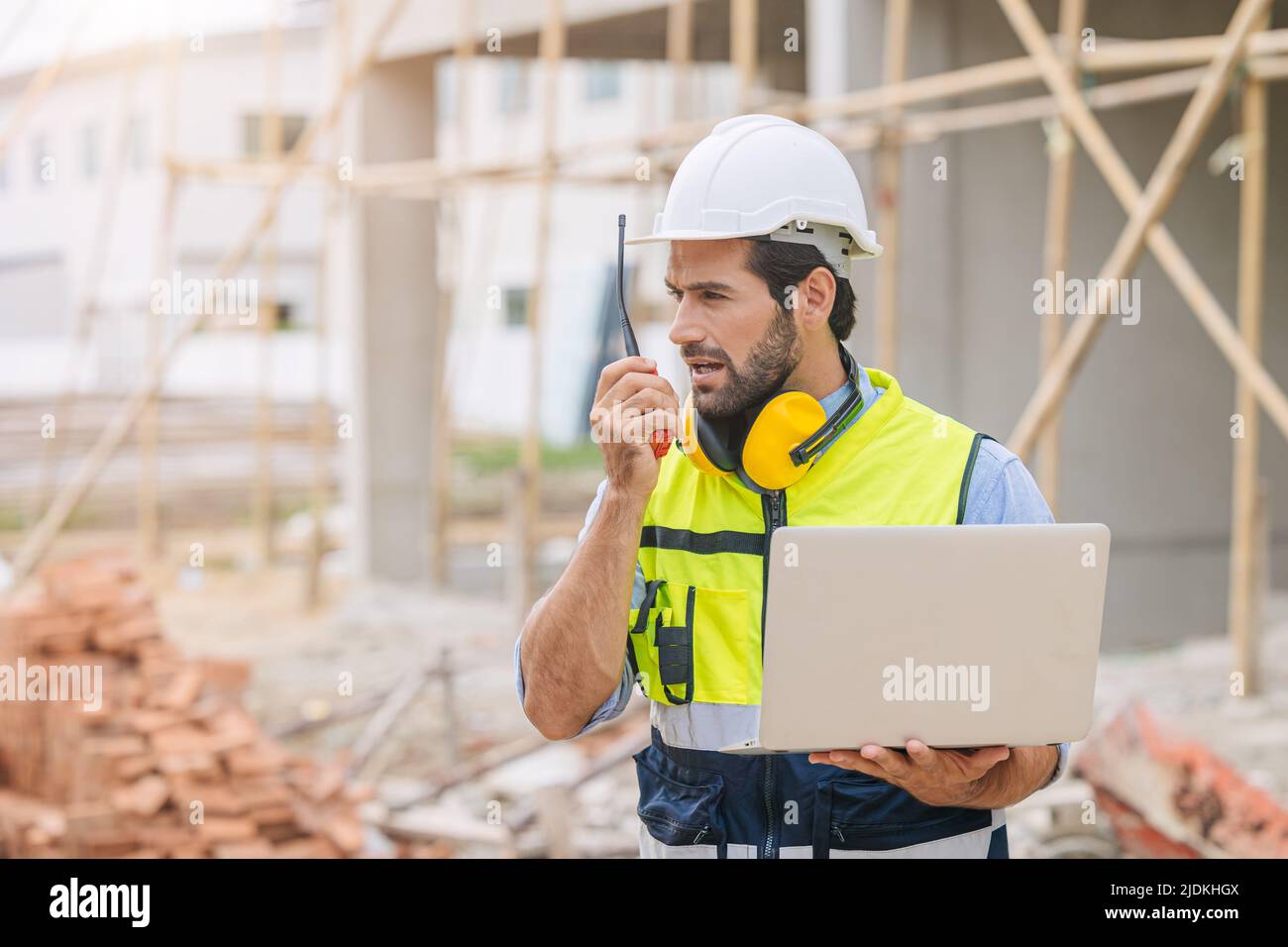 worker foreman engineer builder working using radio command in home ...
