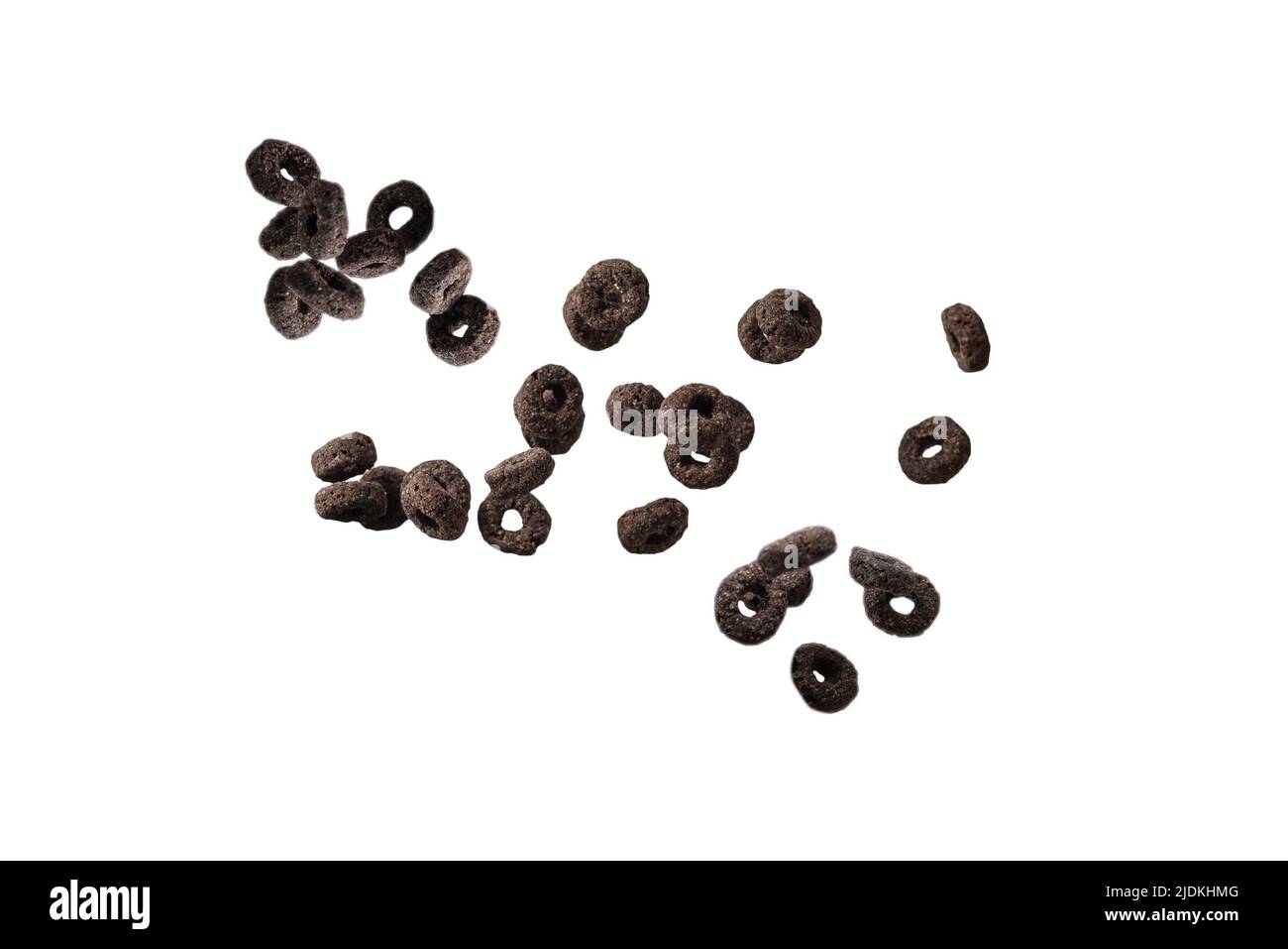 Chocolate rings cereal spill out into a bowl. Breakfast. Isolated on a ...