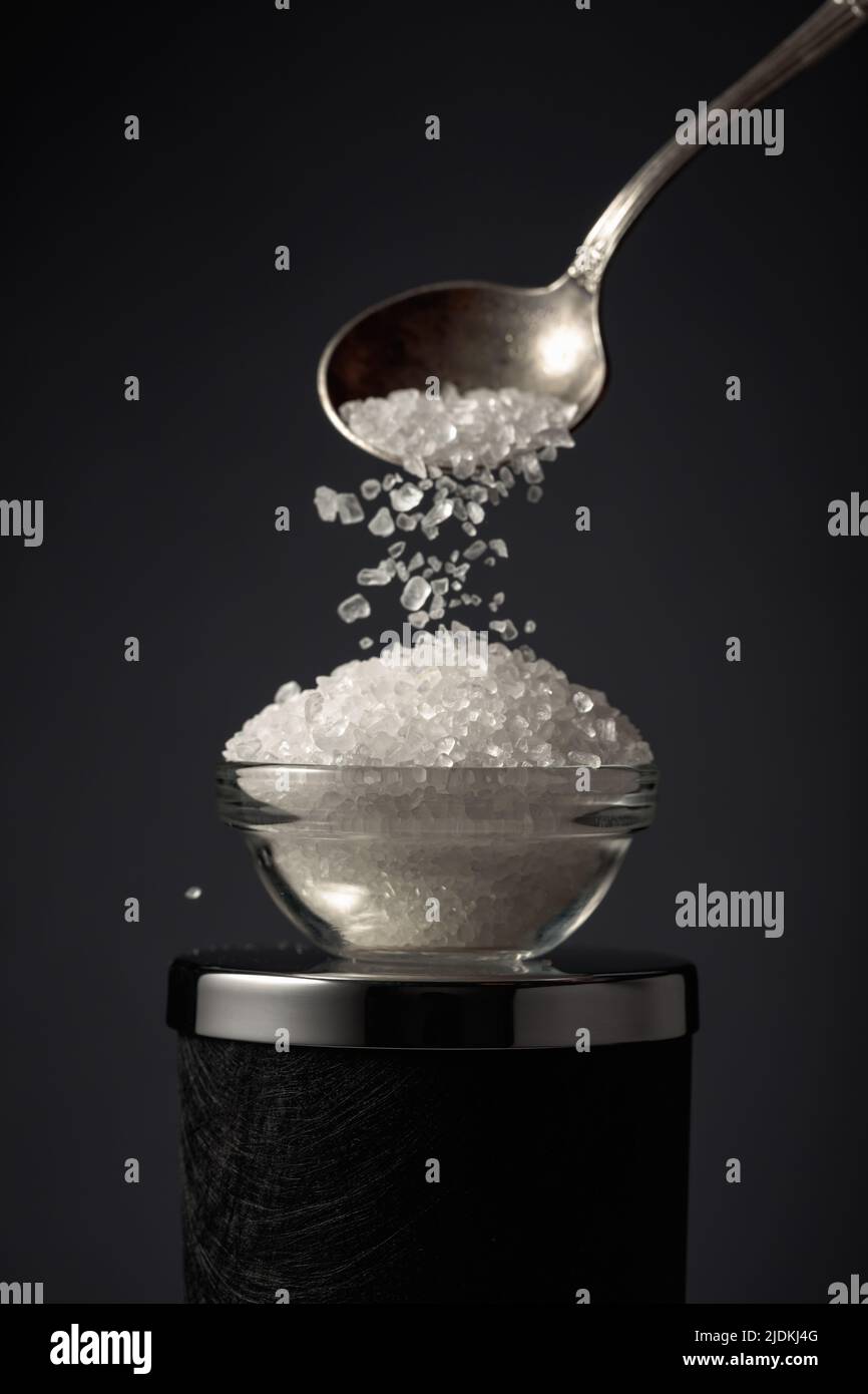 Sea salt is poured into a small glass bowl Stock Photo - Alamy