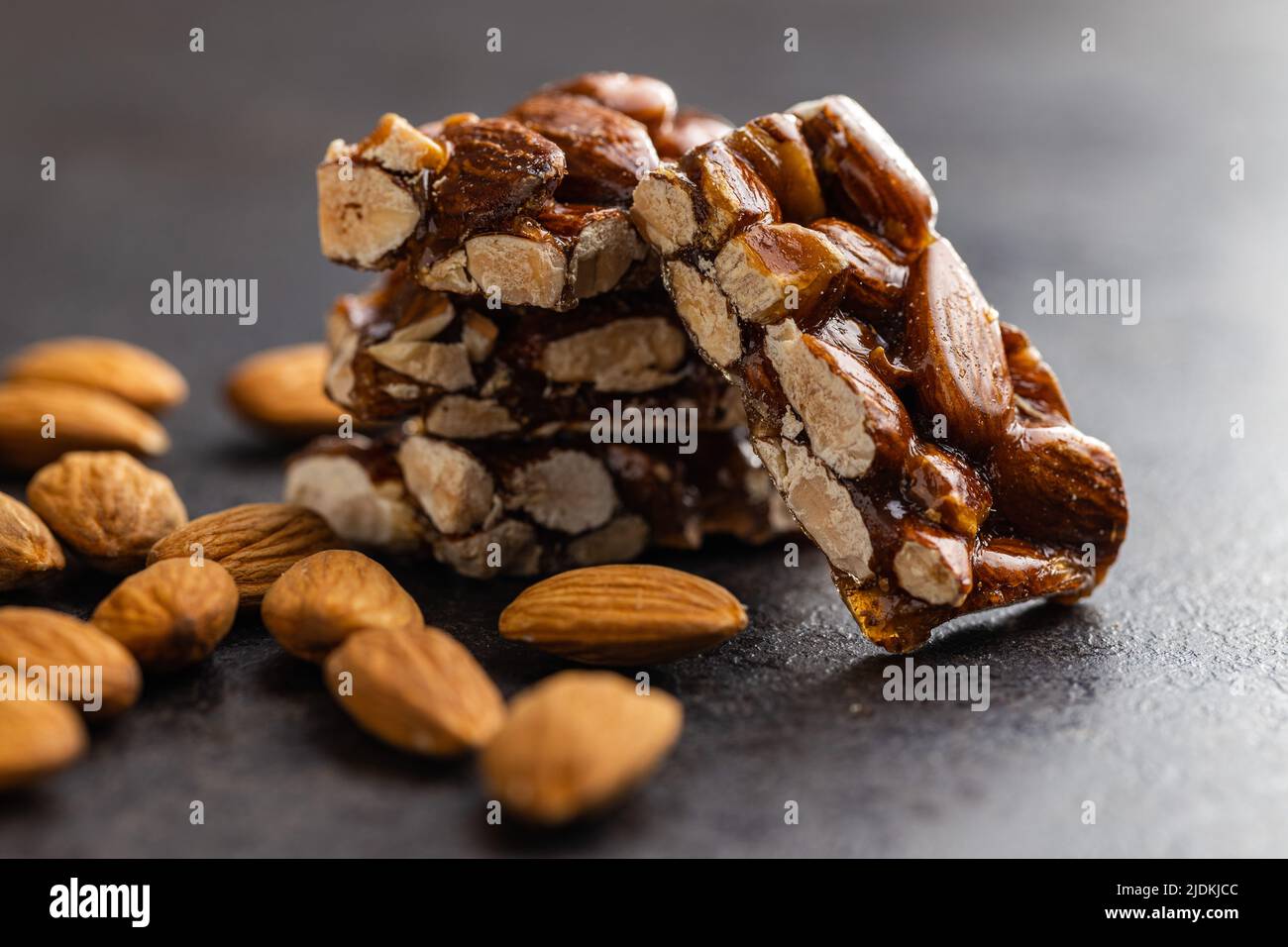 Sweet mini almond bars on a black table Stock Photo - Alamy