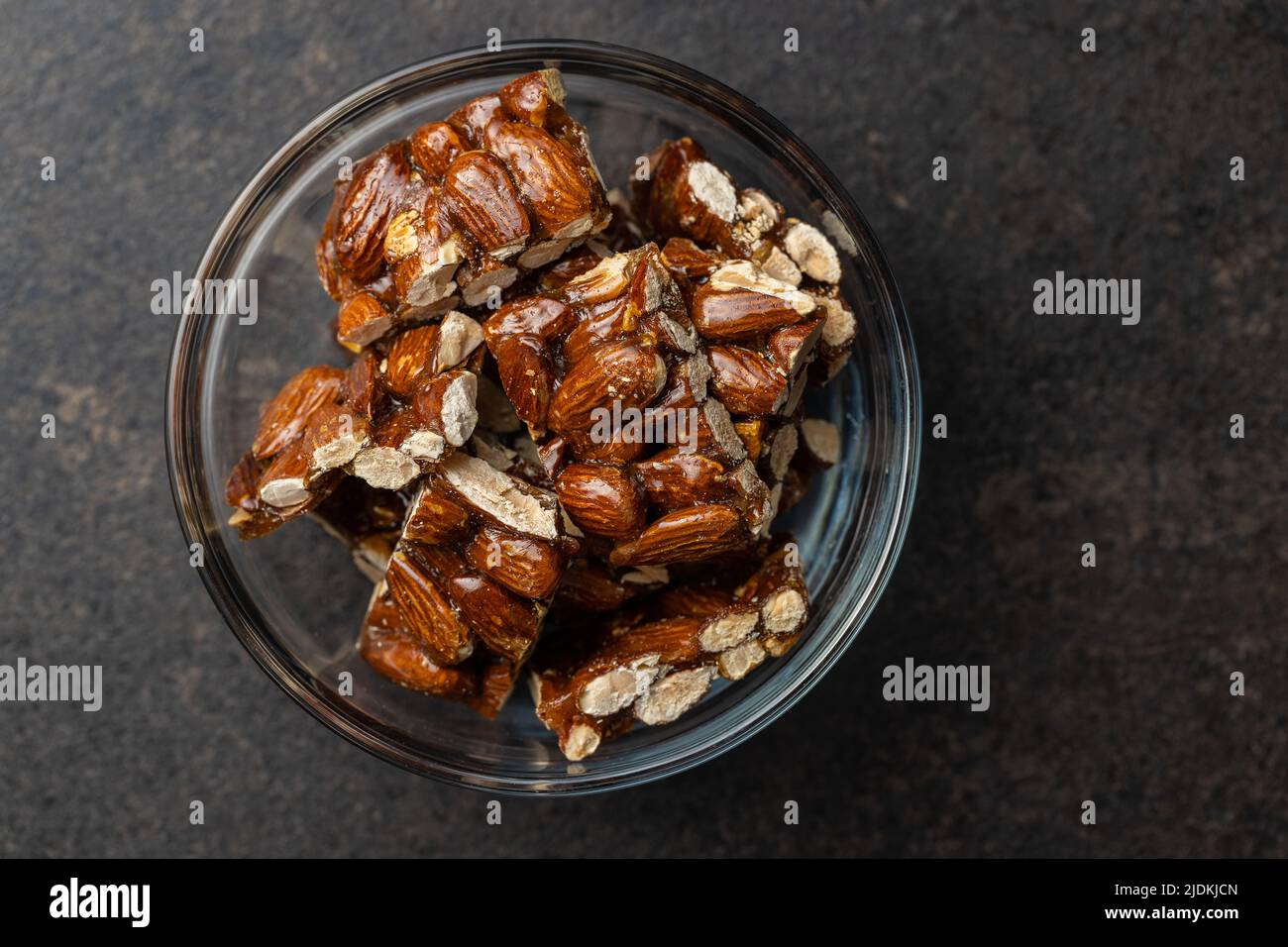 Sweet mini almond bars on a black table. Top view Stock Photo - Alamy