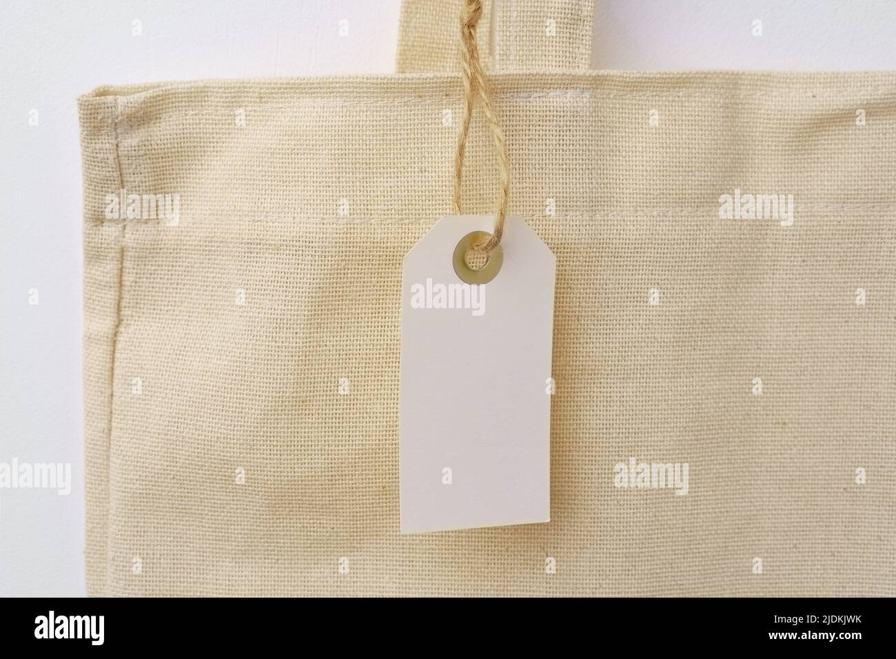 Eco bag for shopping with blank tag on white background Stock Photo - Alamy