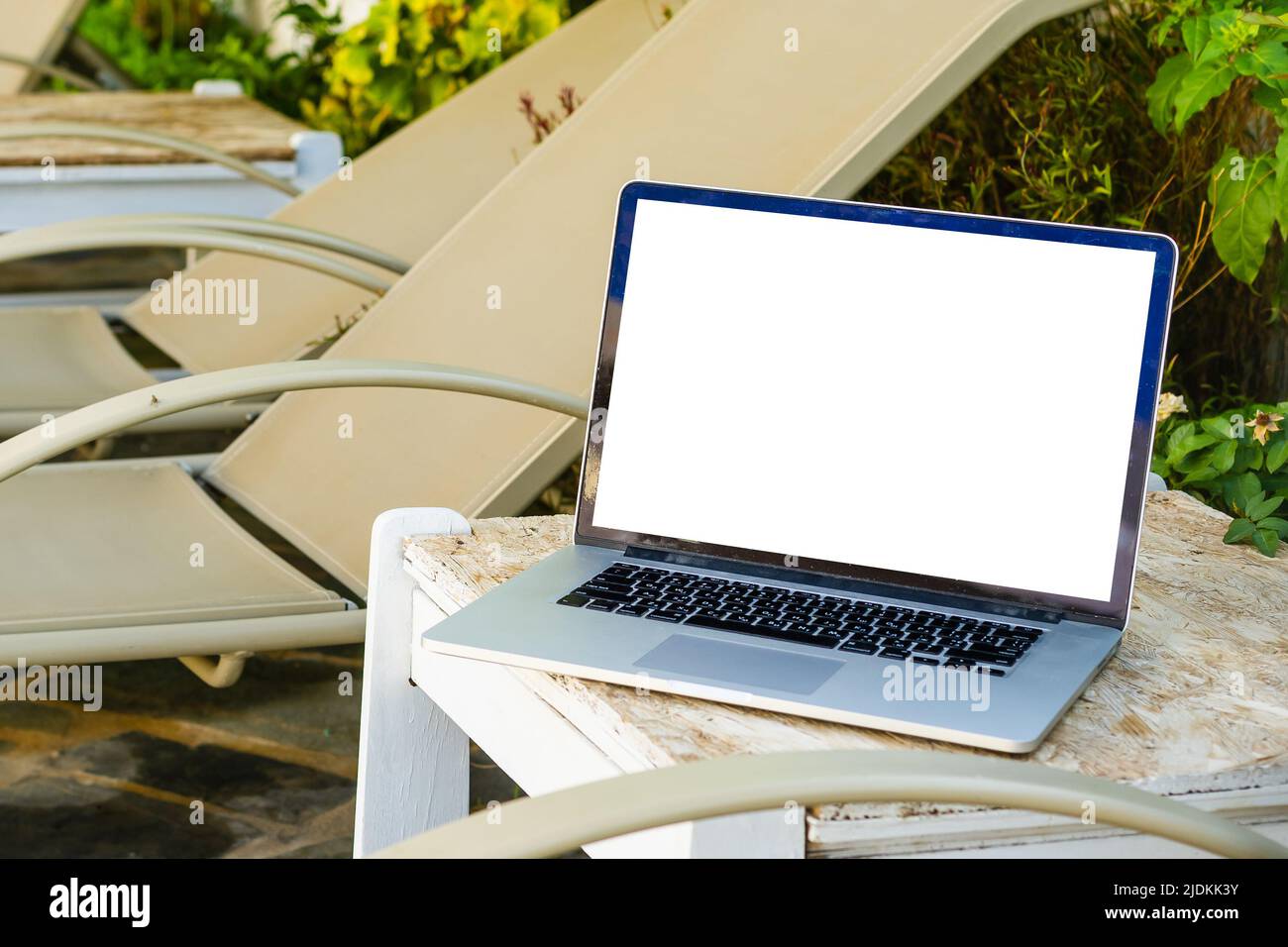 grey laptop computer open with keyboard on deckchair Stock Photo - Alamy