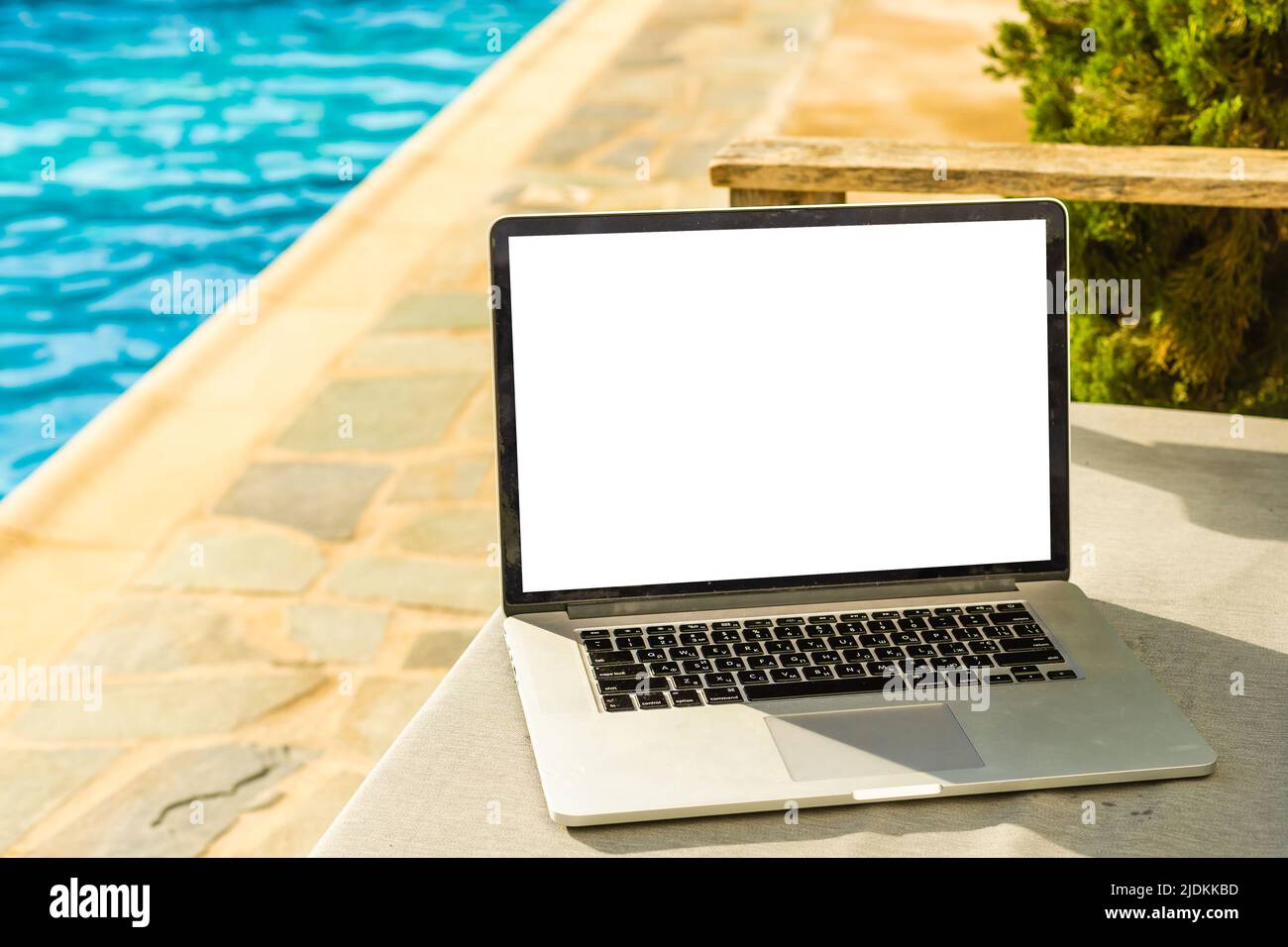laptop with blank screen near the pool Stock Photo - Alamy