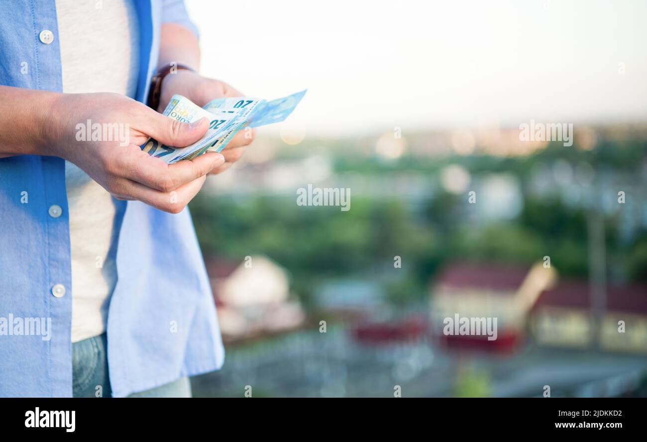 Guy crop view recounting cash money banknotes blur outdoors, copy space ...