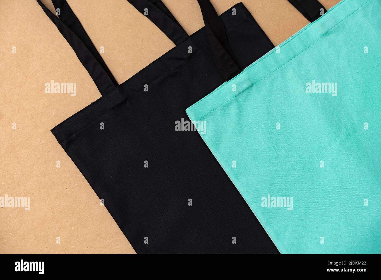 Black textile shopping bag on beige background flat lay Stock Photo - Alamy