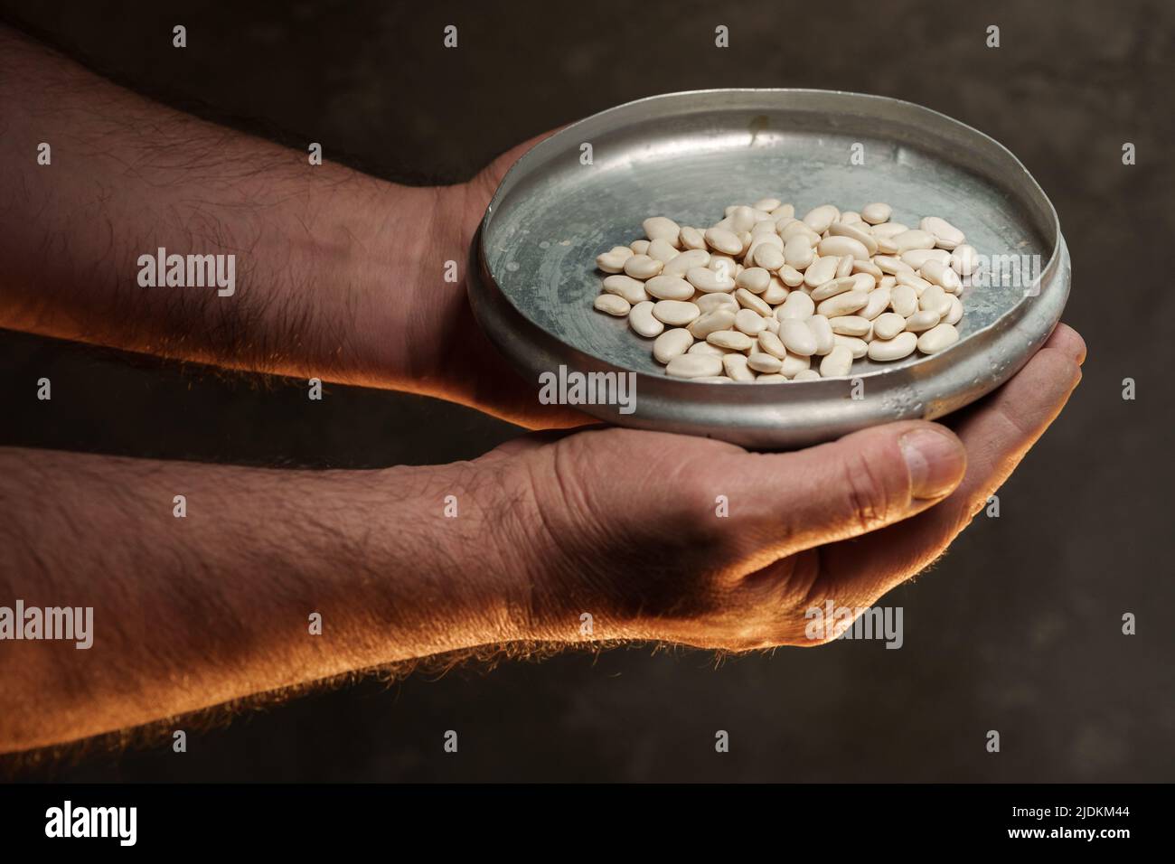 Male hands holding grains of dry kidney beans on dark background Stock ...