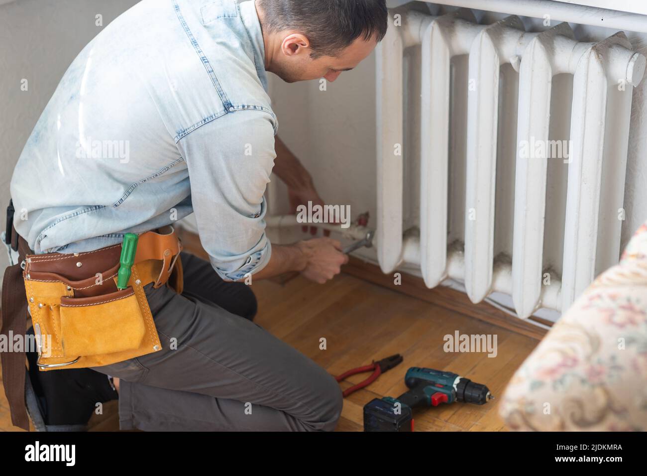Repair heating radiator close-up. man repairing radiator Stock Photo ...