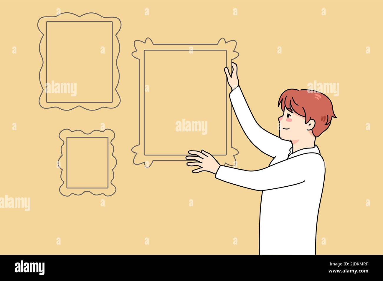 Man hanging frames with family pictures on wall. Happy male putting ...