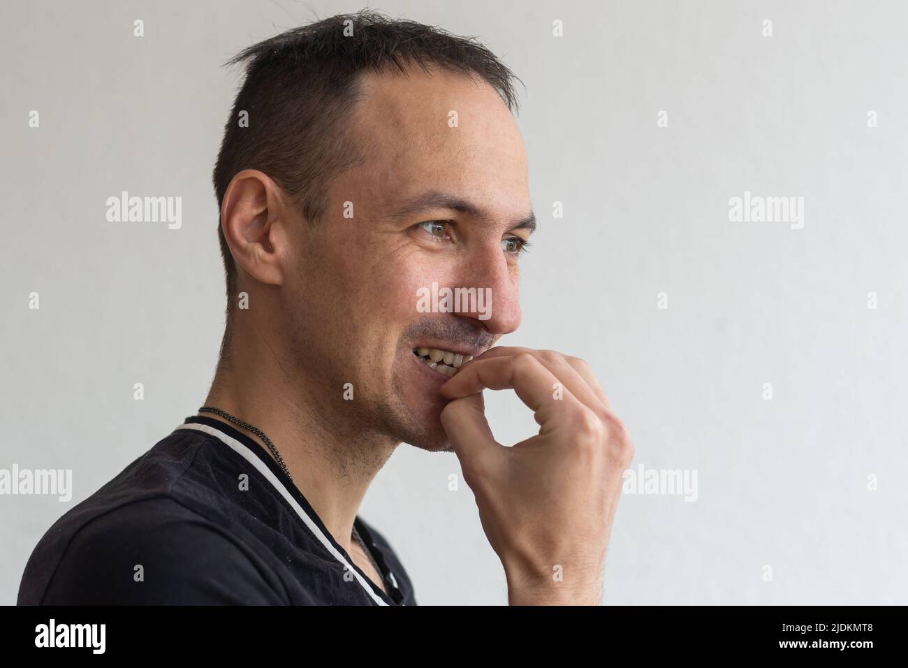 Scared man biting nails hi-res stock photography and images - Alamy