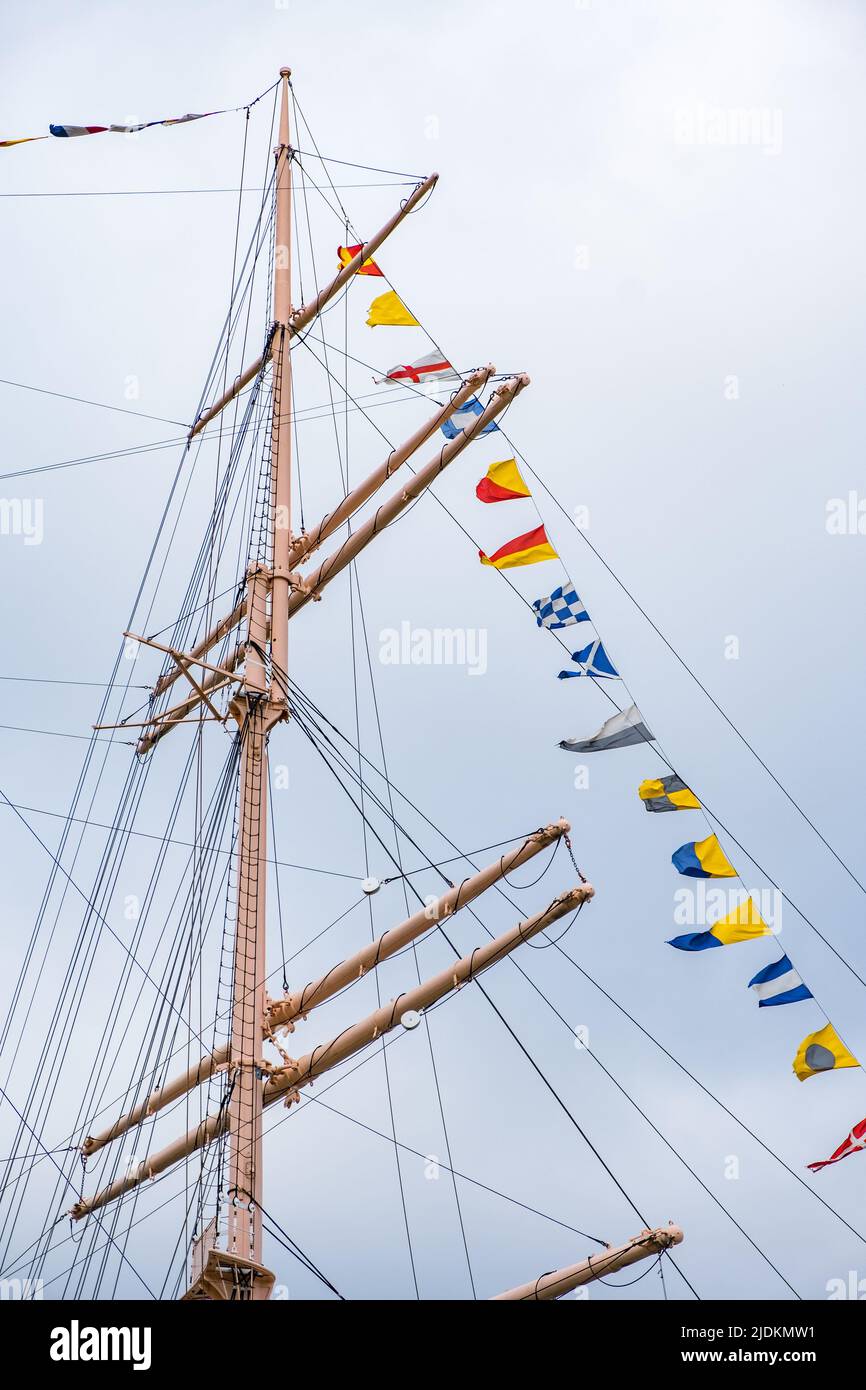 Ship's mast with colorful pennants against the sky Stock Photo - Alamy