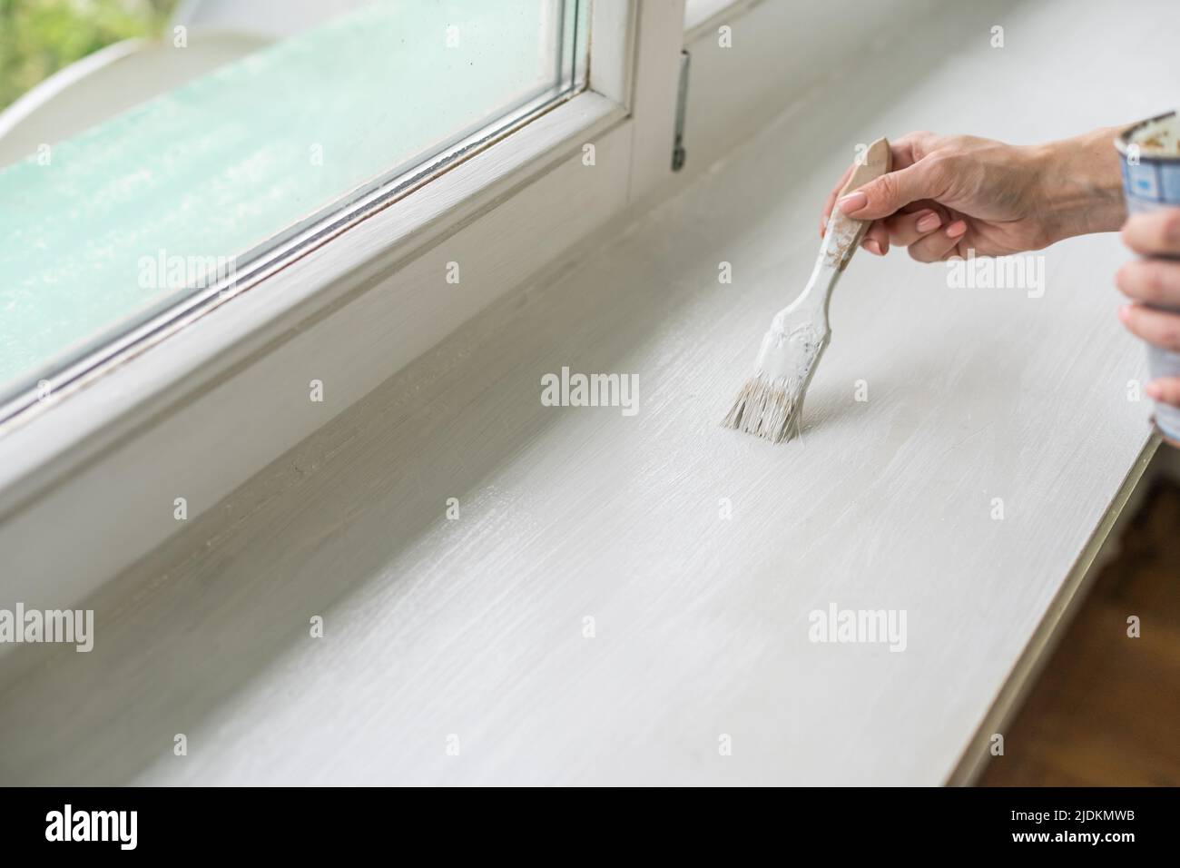 painting a window frame with white color Stock Photo - Alamy