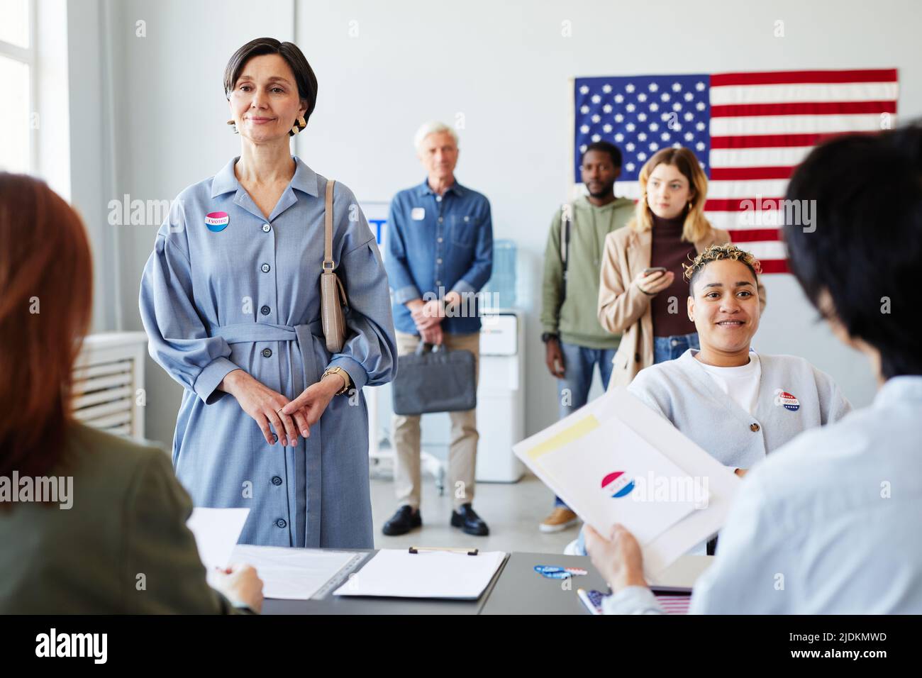 Front view portrait of diverse people standing in line on voting day in ...