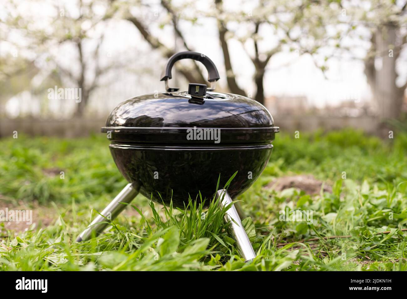 An empty barbecue grill stands in the yard Stock Photo - Alamy