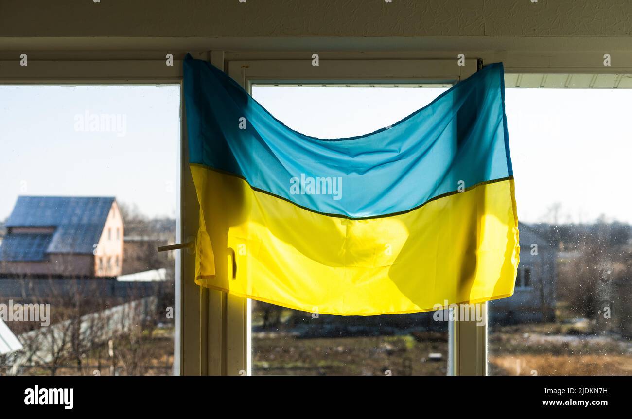Support Ukraine. Ukrainian flag on the window. Place for text Stock ...