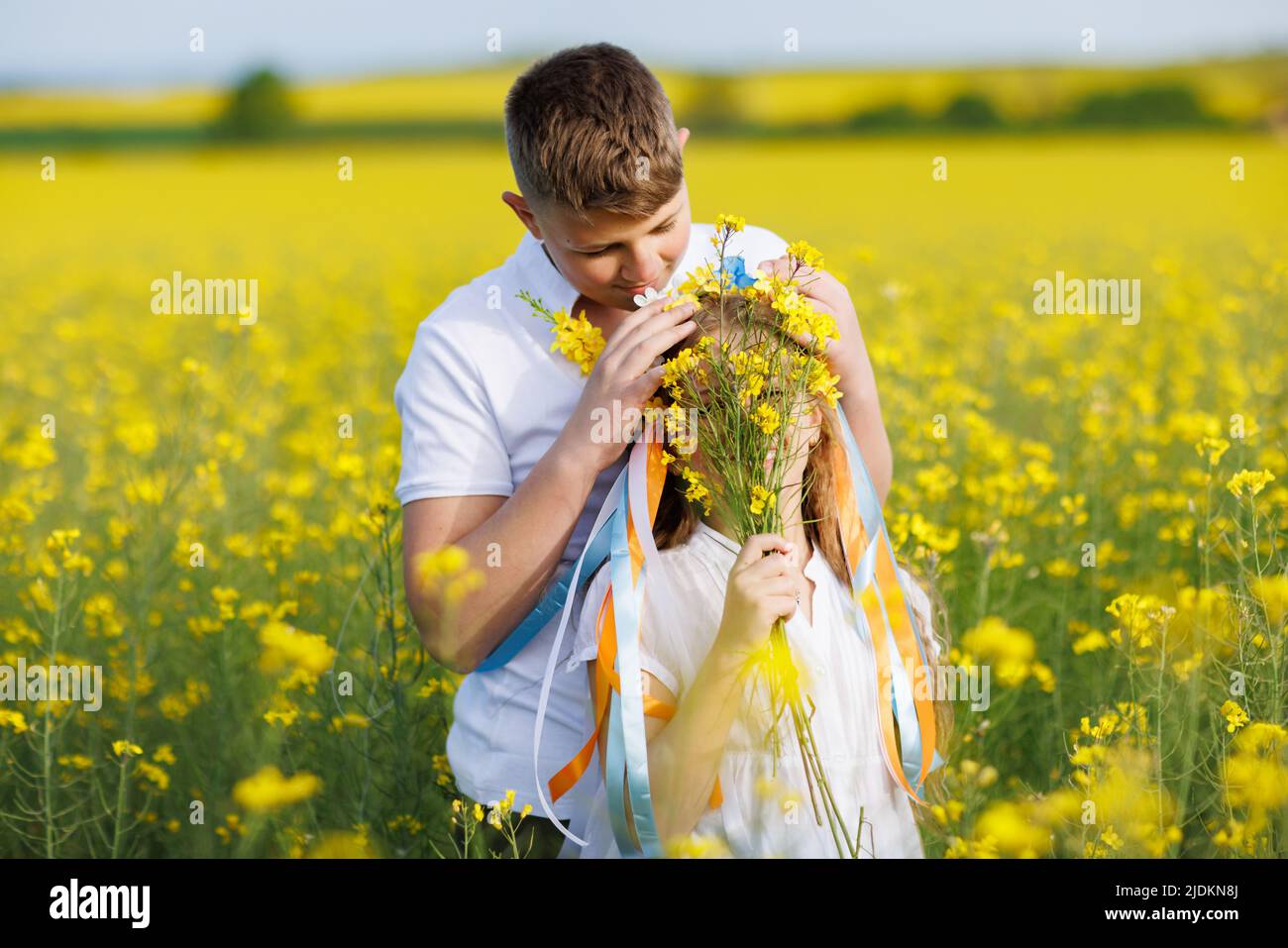 Front view of happy carefree native children: older teenage brother and ...