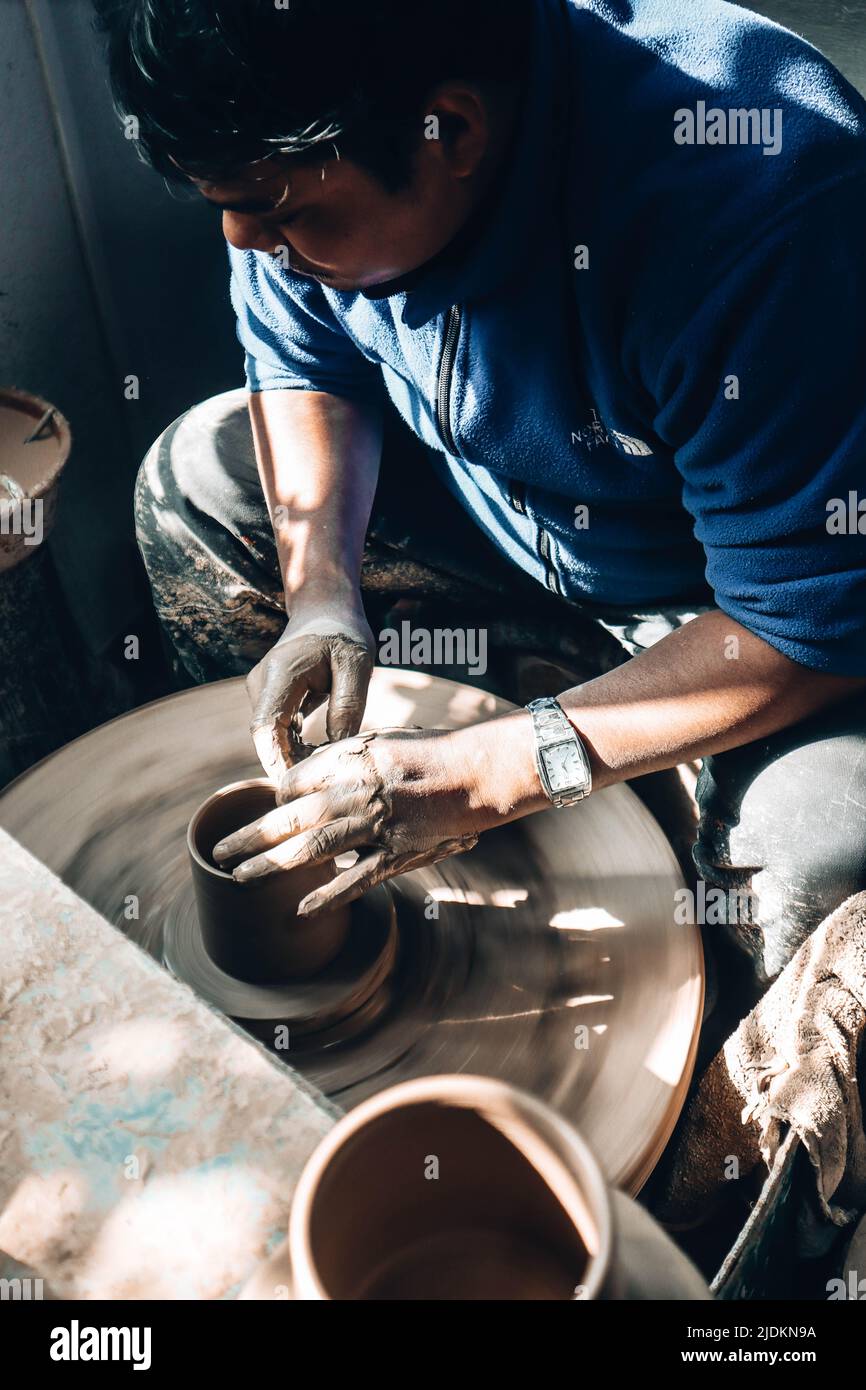 Visit to Thimi Ceramics in Bhaktapur, potter making a vase or a mug ...