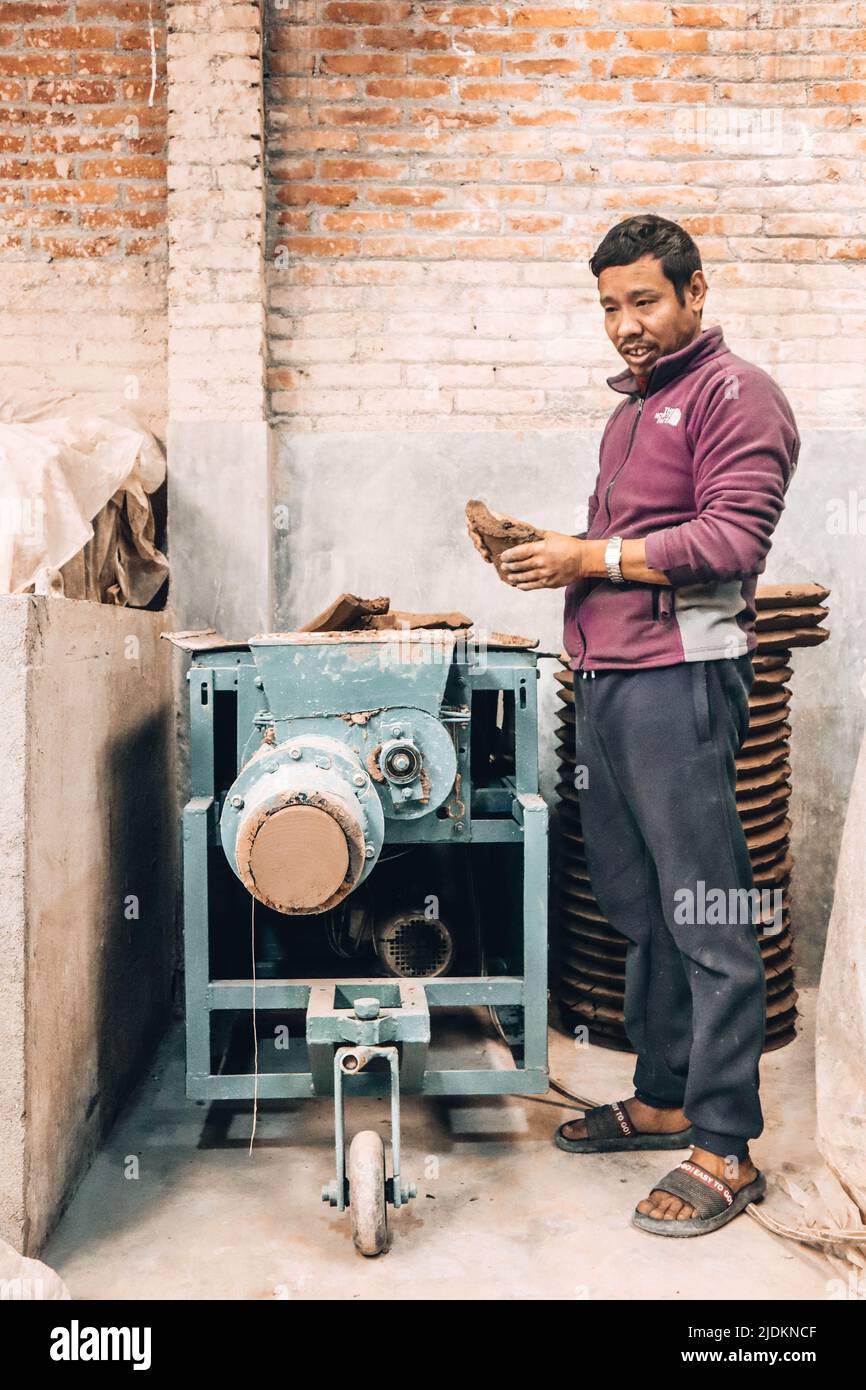 Visit to Thimi Ceramics in Bhaktapur man showing how the clay is ...