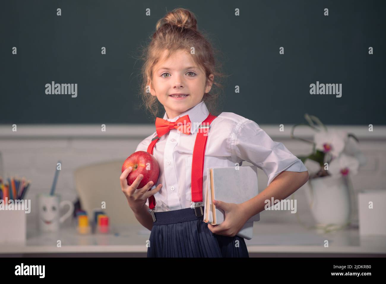 Cute child at school. Kid is learning in class on background of ...