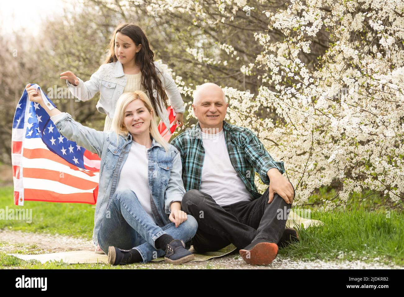 american family with USA flag outdoors Stock Photo - Alamy