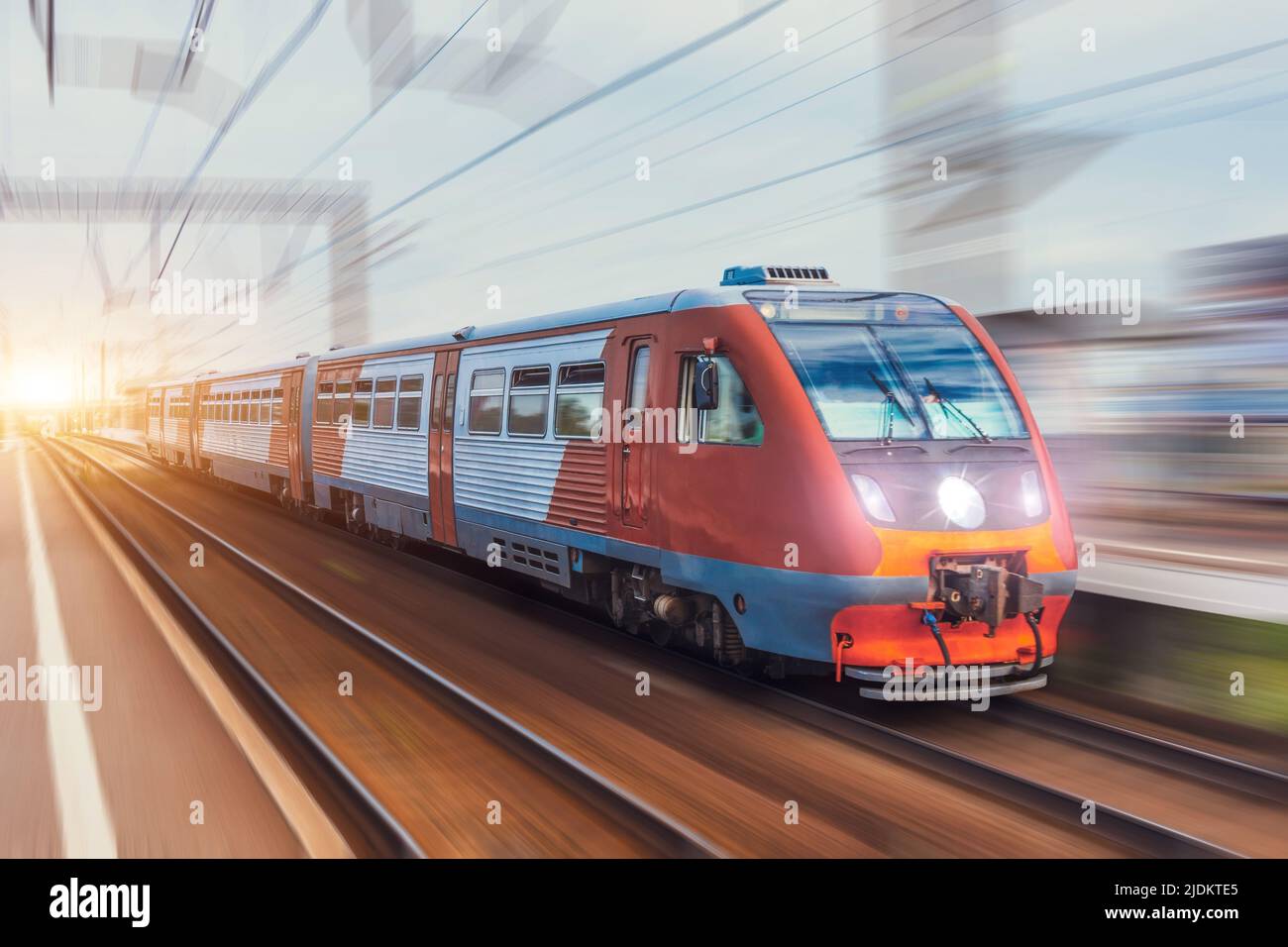 Passenger train travels by railway motion blur effect Stock Photo - Alamy