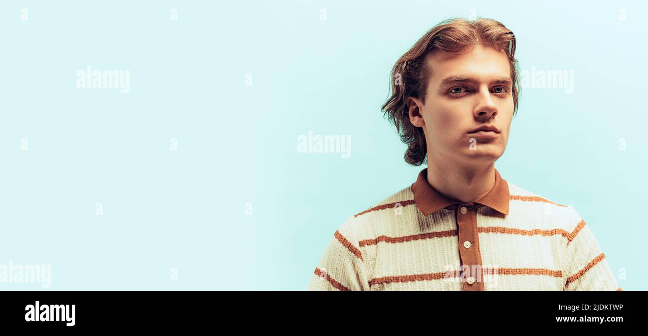 Portrait of young handsome man in shirt posing, seriously looking at ...