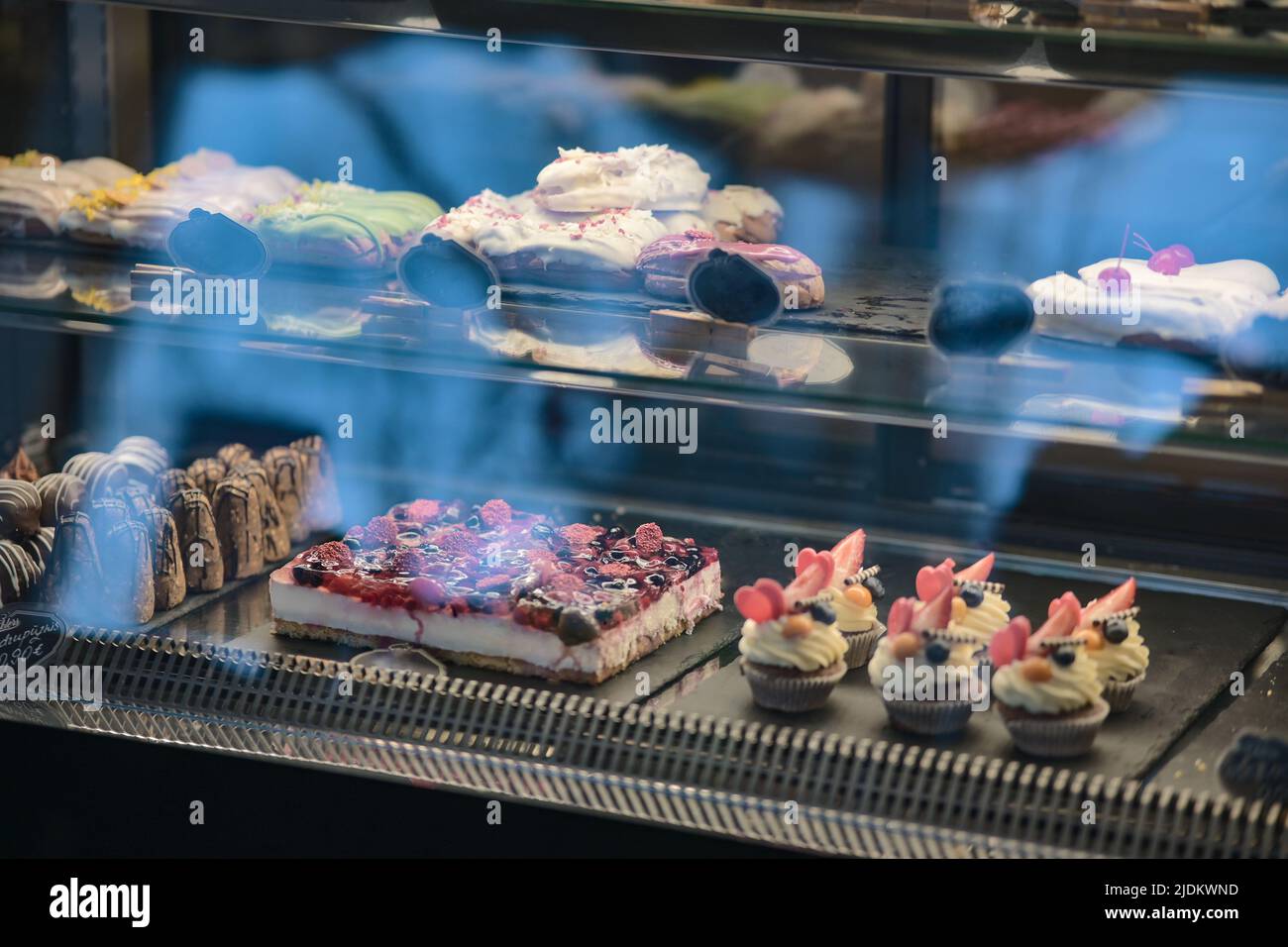 A counter with pastries in a bakery. Buns and cakes on the counter in a ...