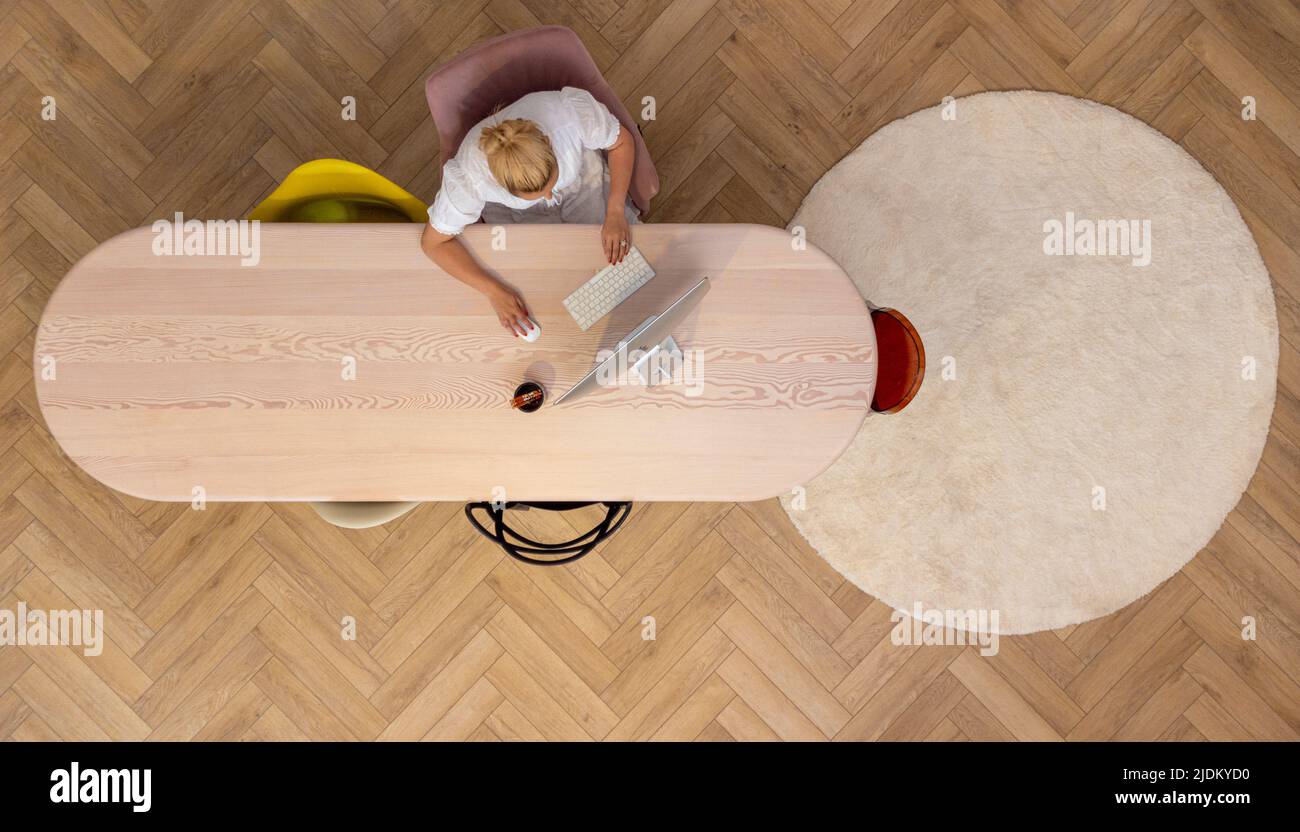 Aerial view of a small contemporary office with a young caucasian ...