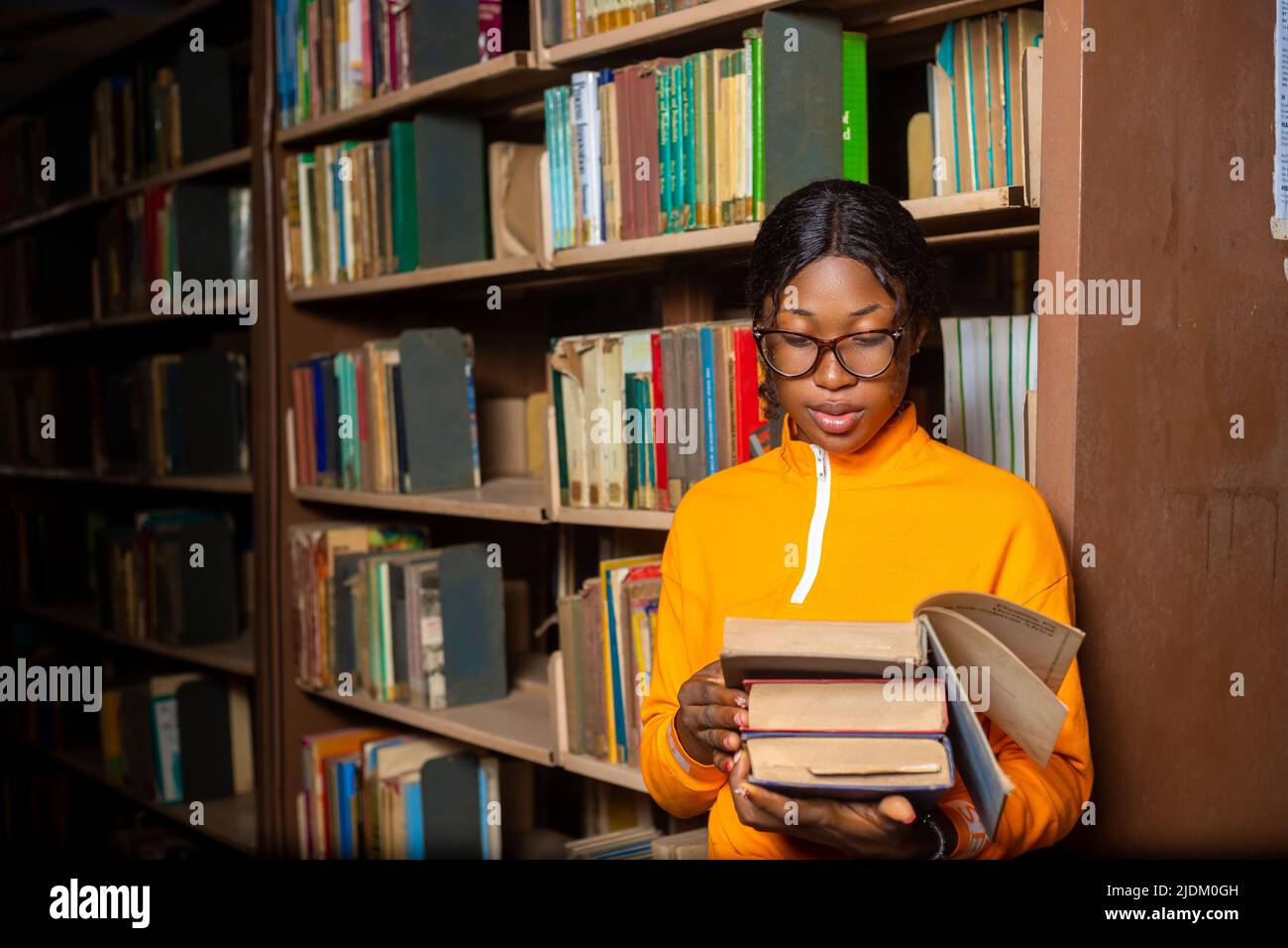 beautiful girl in a library. lady reading book in the library Stock ...