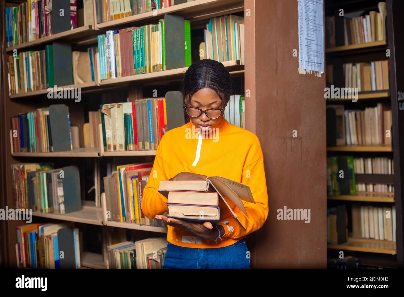 beautiful lady in the library studying her project Stock Photo - Alamy