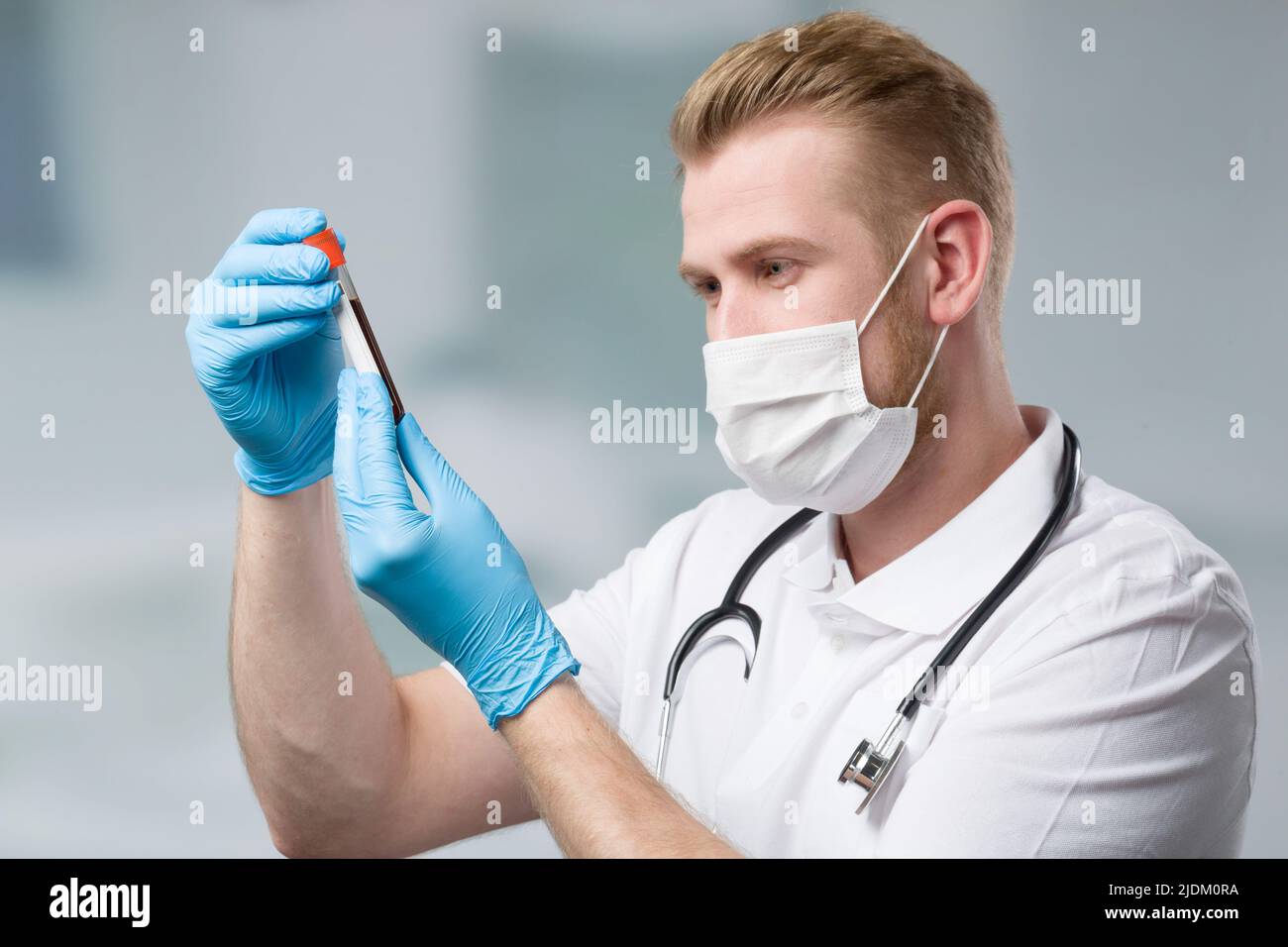 young medical doctor with a blood probe in laboratory Stock Photo - Alamy