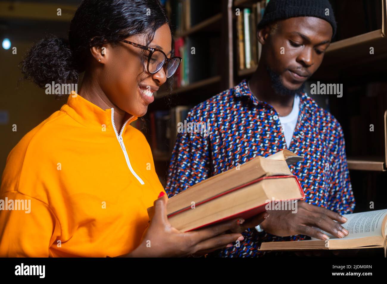 High school - two students with book in classroom Stock Photo - Alamy