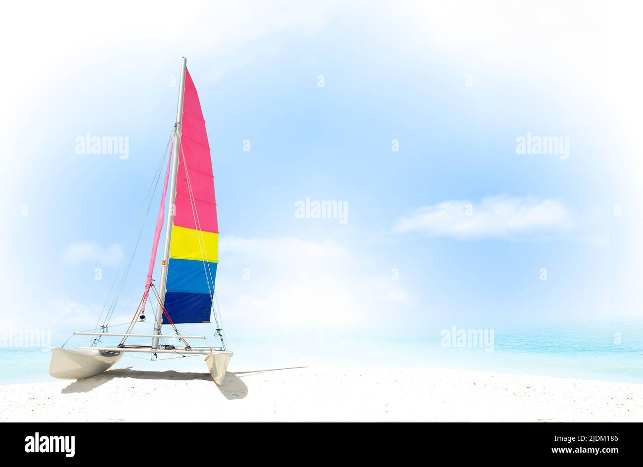 Catamaran on the white beach with sea and blue sky in the background ...