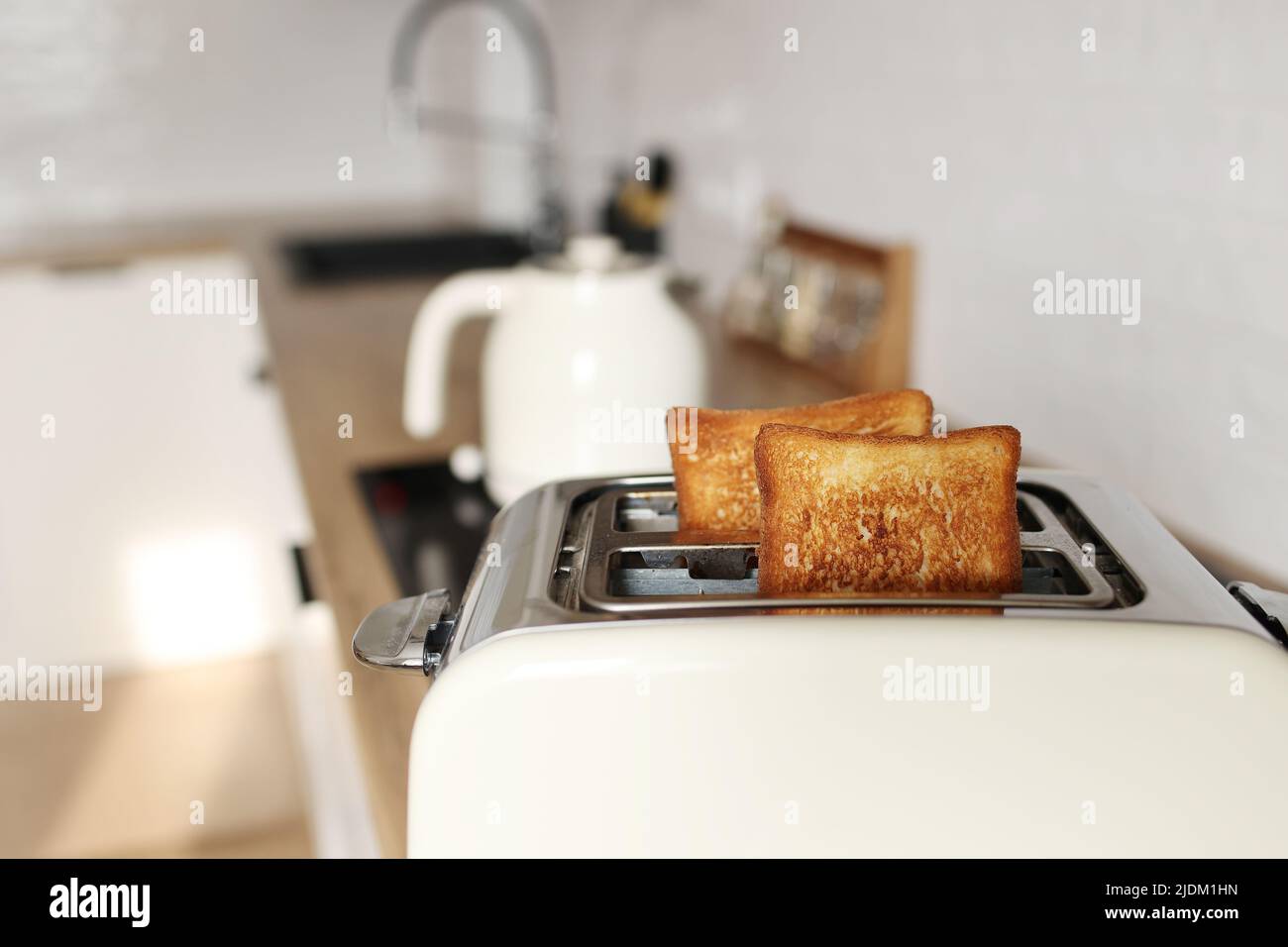 Toasted bread and toaster for breakfast. Modern white toaster and ...